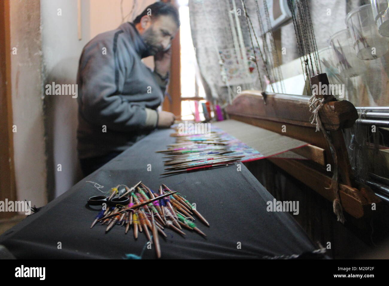 A Kashmiri craftsman weaves a special Kani shawl on a handloom with ...
