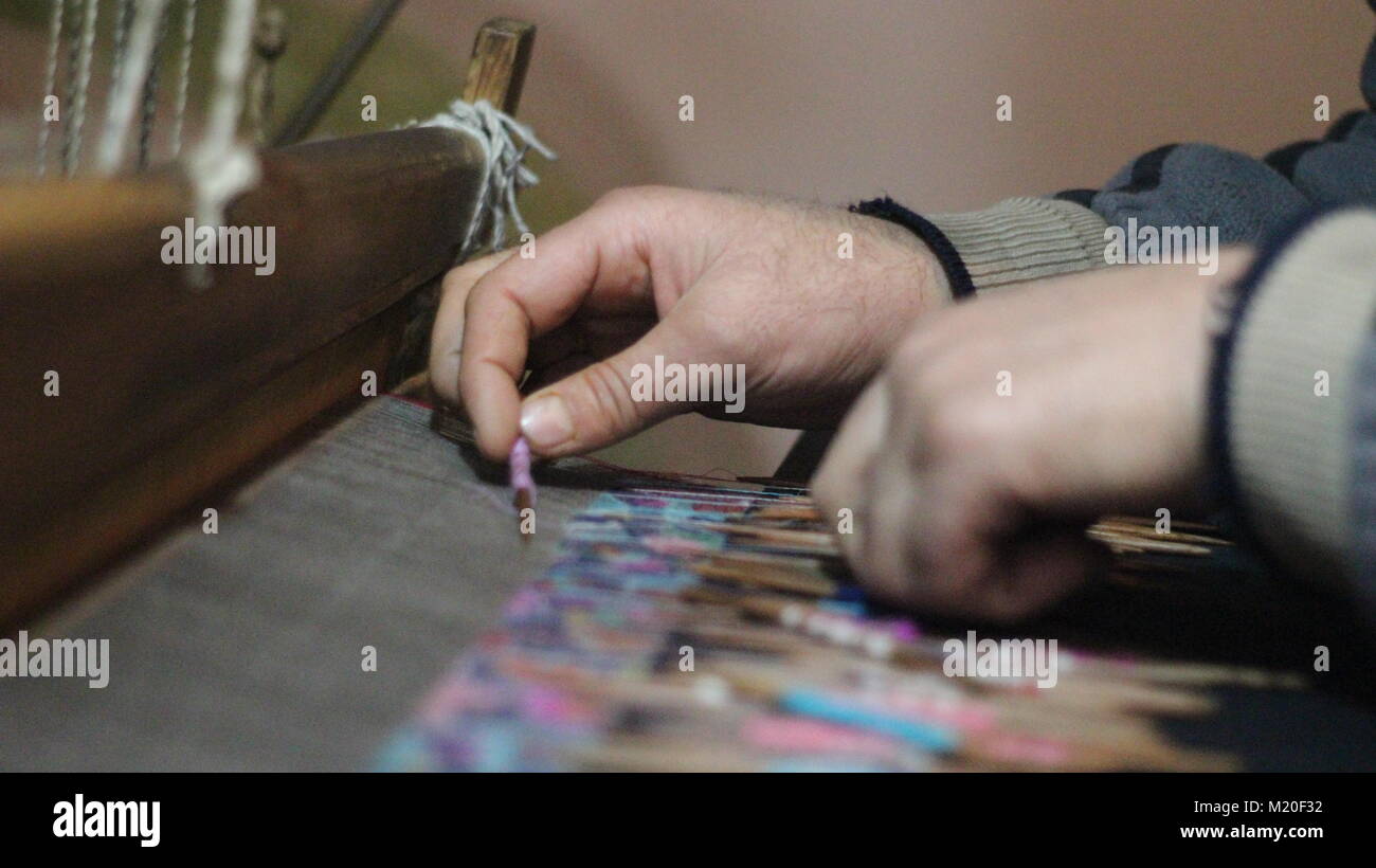 A Kashmiri craftsman weaves a special Kani shawl on a handloom with ...