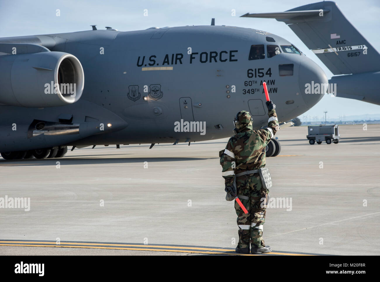 An Airman from the 860th Aircraft Maintenance Squadron marshals in a C ...
