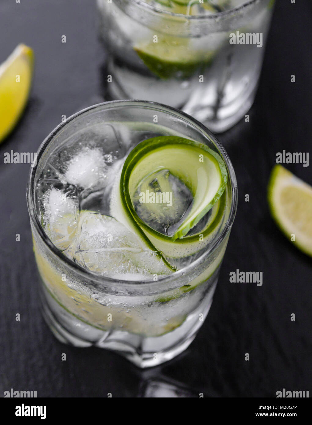 gin tonic with cucumber, lime and ice in glass Stock Photo - Alamy