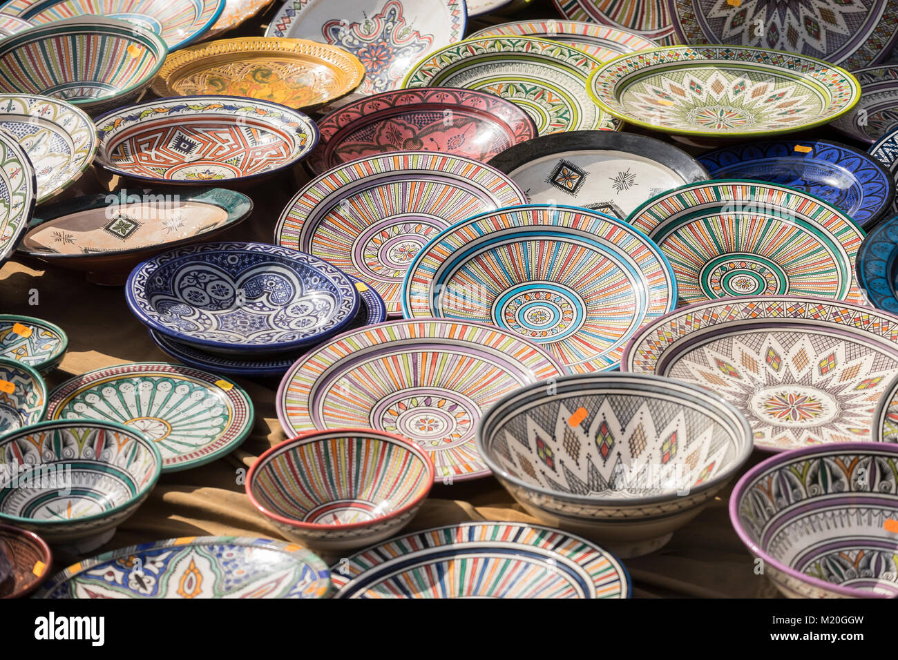 Porcelain, hand-painted dishes of a multitude of colors in a ...