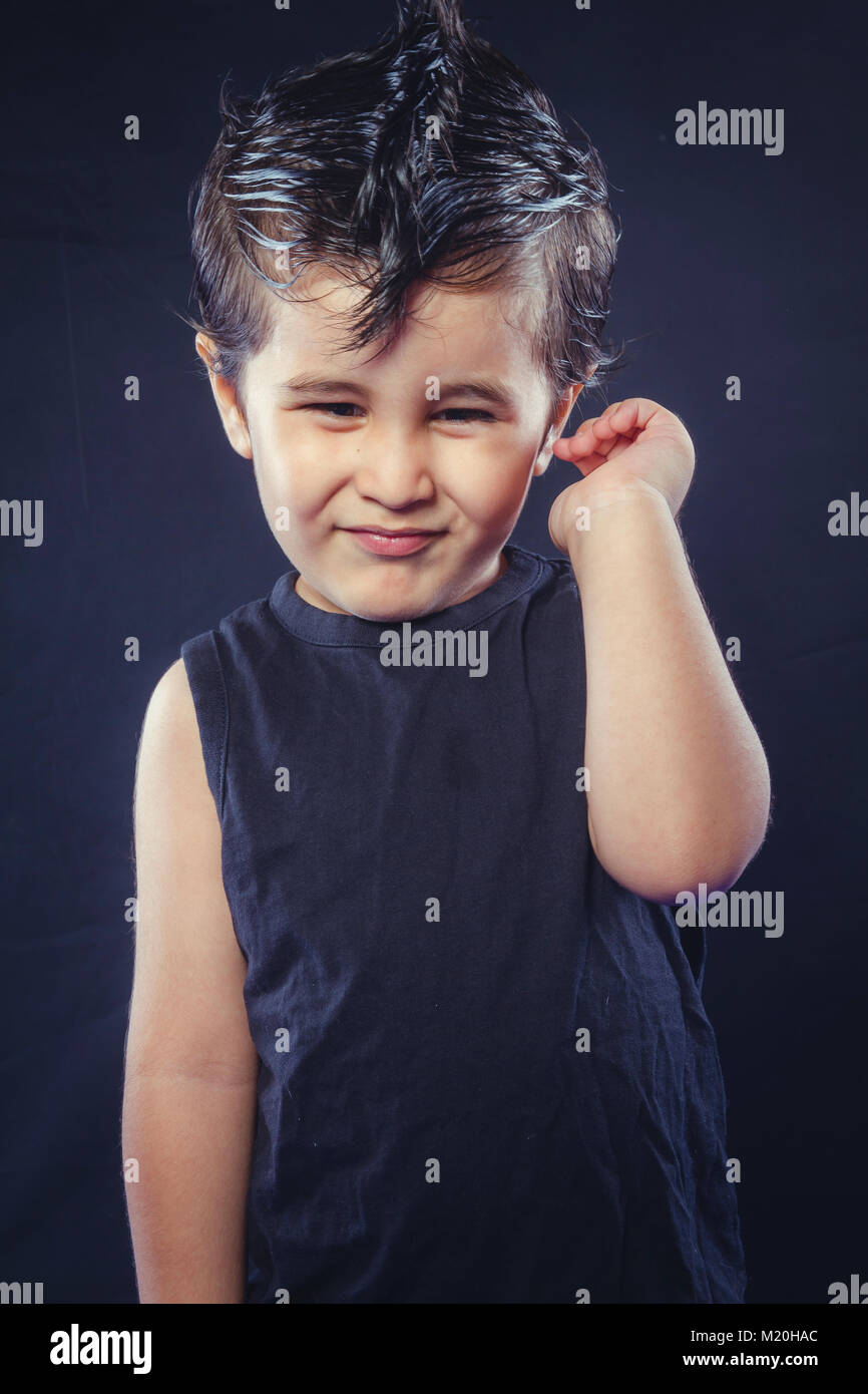 smile, boy with hair gum in rocker dress with funny and expressive ...