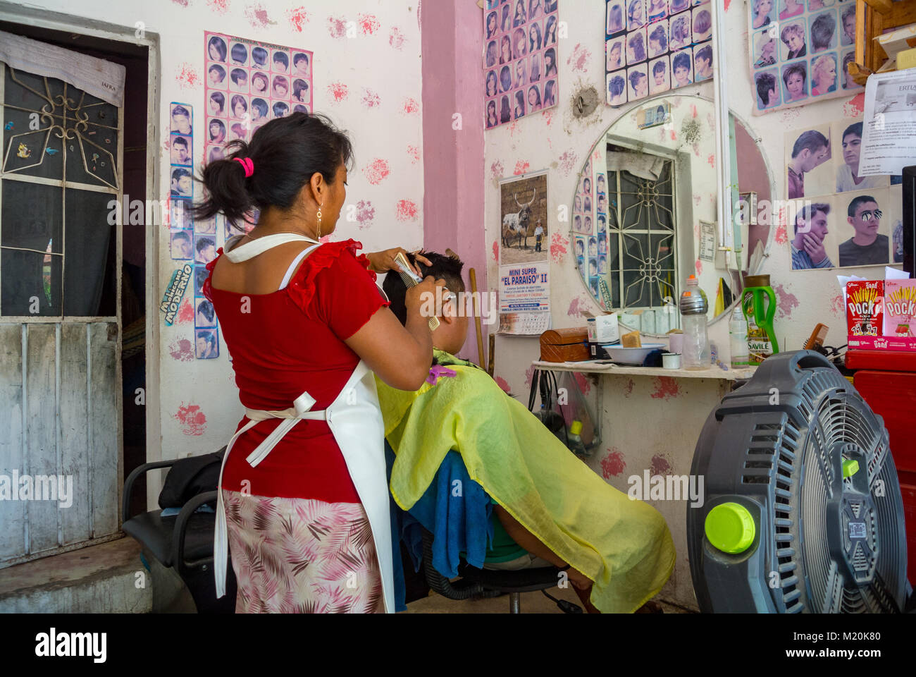Tulum, Quintana Roo, Mexico, Mexican woman cutting the hair of client ...