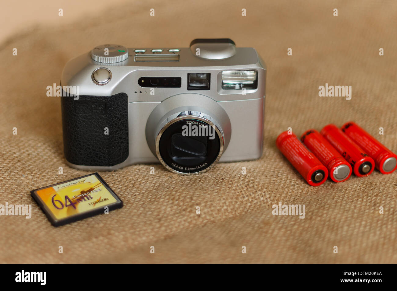 Old camera on fabric background with batteries and memory card Stock ...