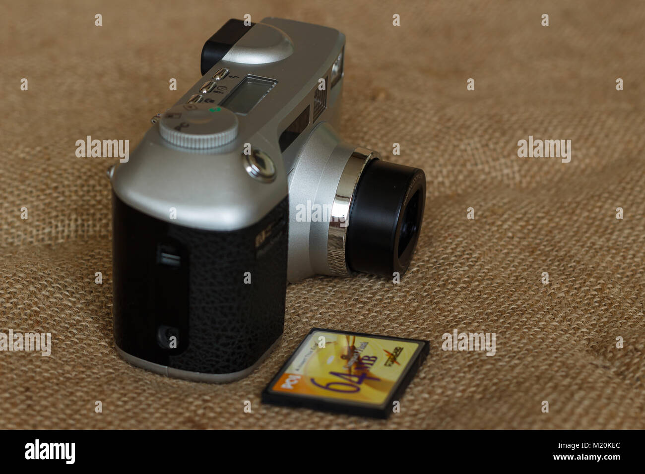 Old camera on fabric background with memory card side view Stock Photo ...