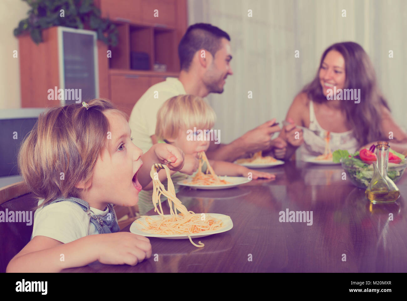 Mother daughter eating pasta together hi-res stock photography and ...