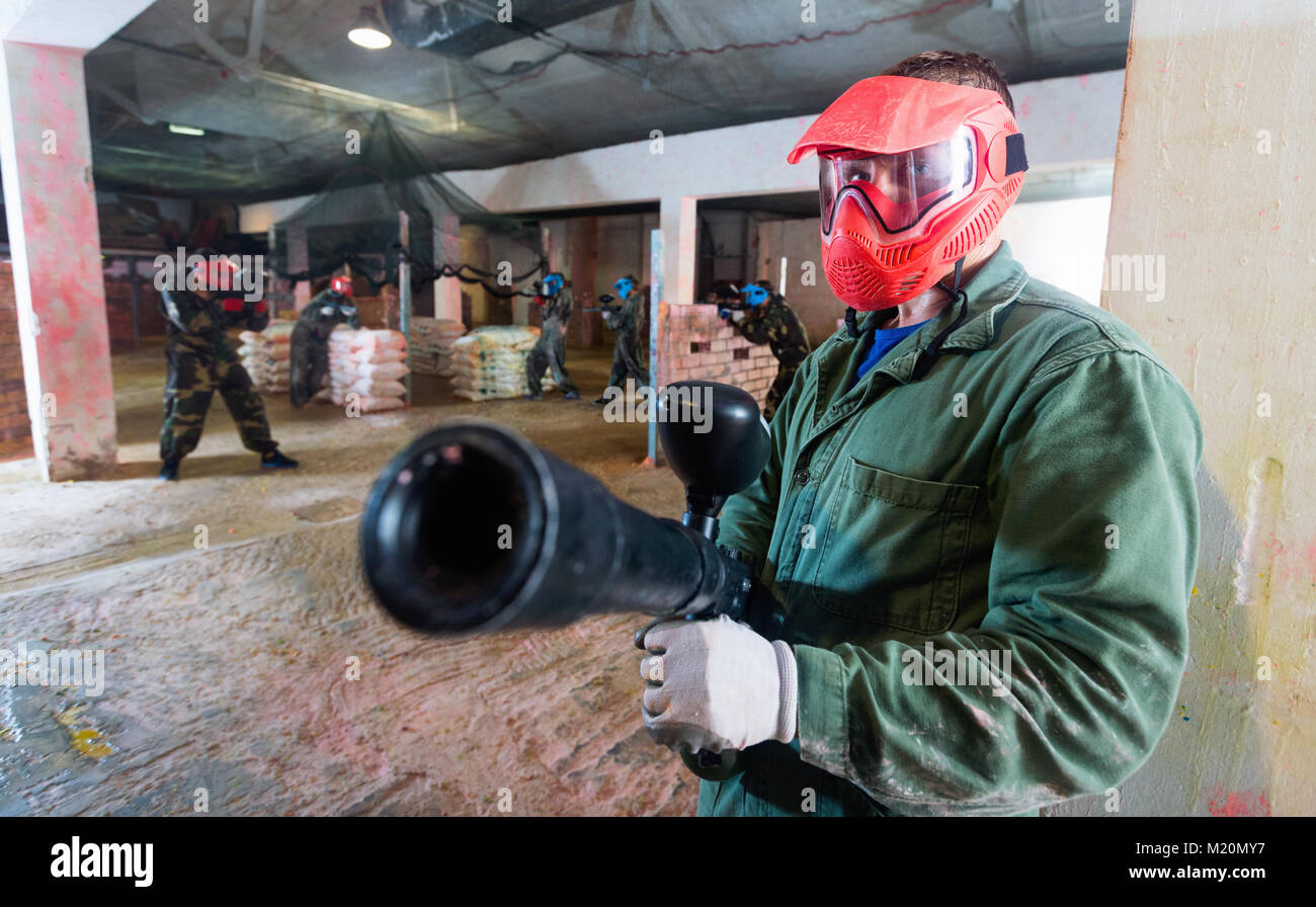 Portrait of red team happy cheerful positive player who is aiming in ...