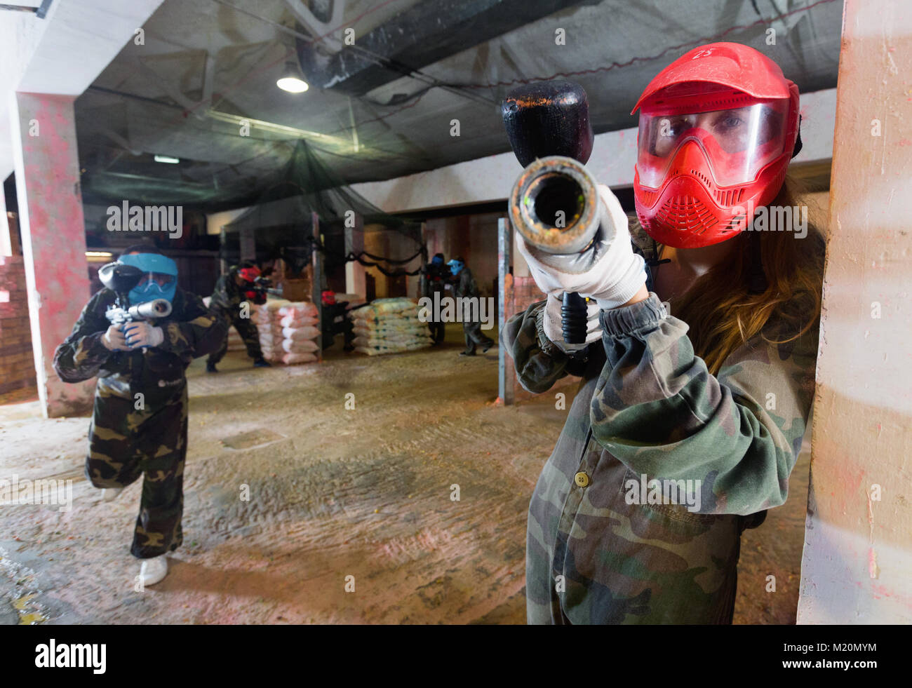 Portrait of red team cheerful positive player who is aiming in ...