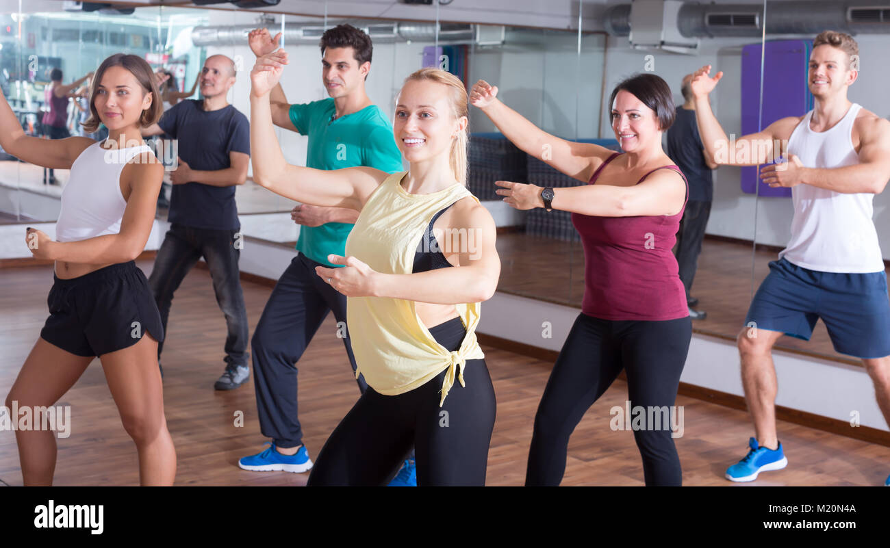 Young happy beginner dancers learning zumba elements together Stock ...