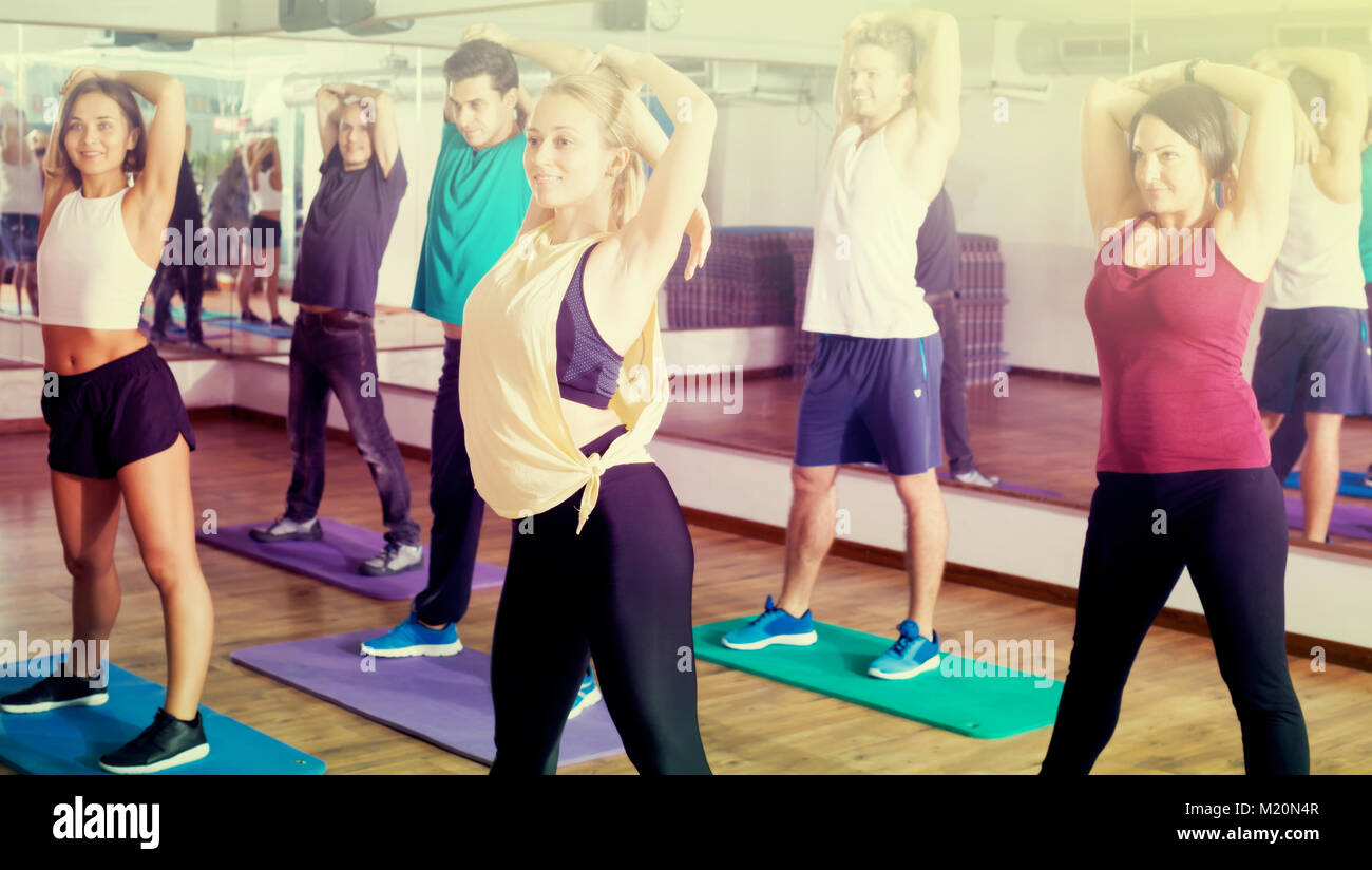 Young happy people studying zumba elements in dancing class Stock Photo ...