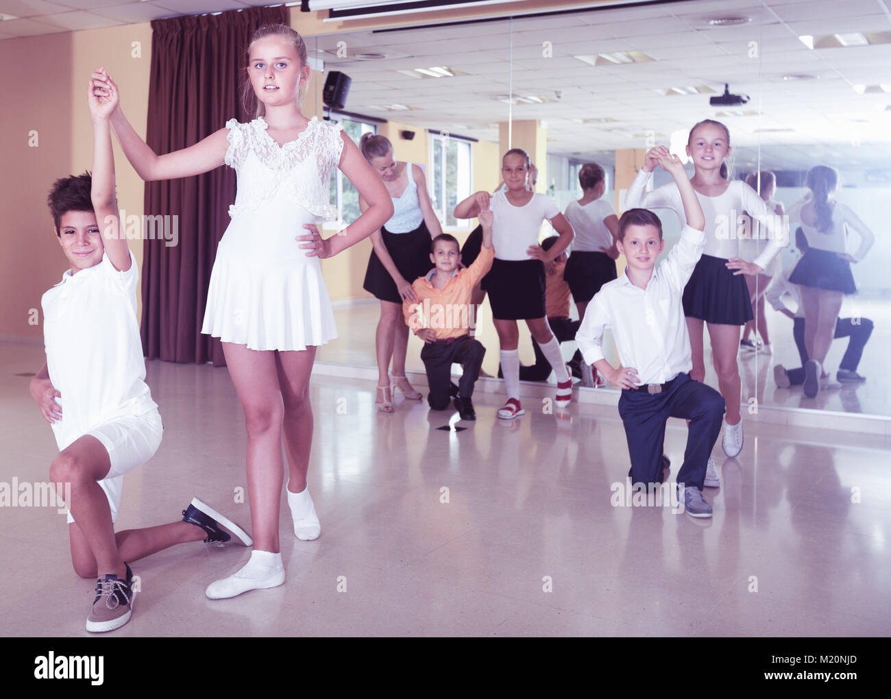 Group of friendly smiling positive children dancing tango in dance ...