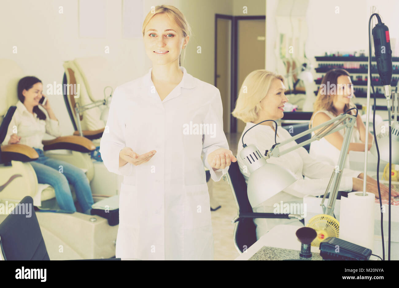 Smiling person showing her workplace in nail salon Stock Photo - Alamy
