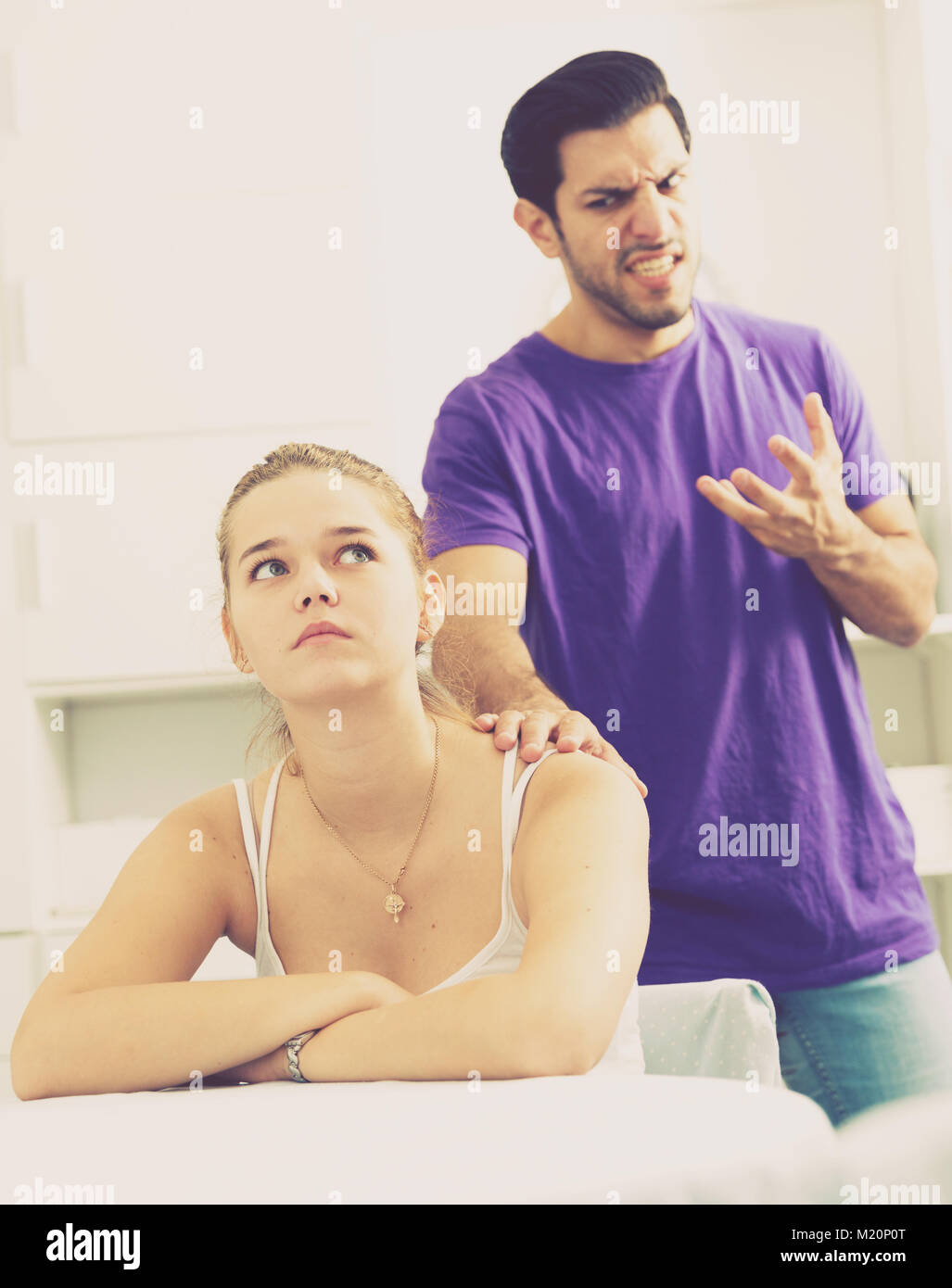 Portrait of woman gesturing with man sitting behind her hi-res stock ...