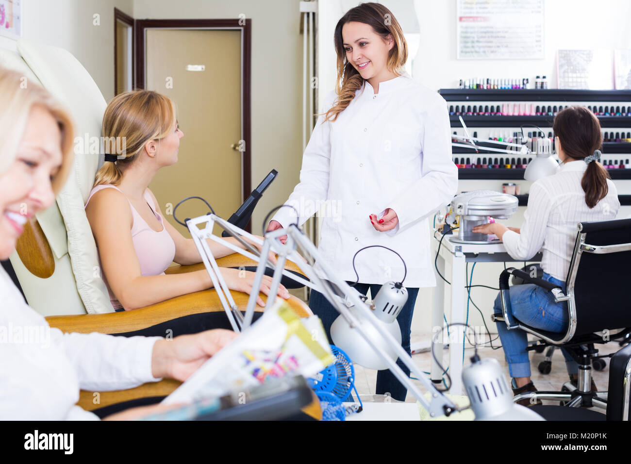 Woman doing nails displaying her workplace in nail salon Stock Photo ...