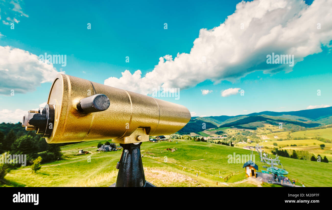 Golden tourist telescope and blurred Pieniny mountains landscape in the ...