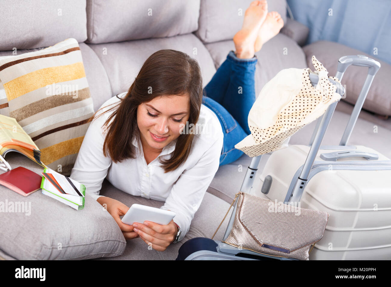 Young smiling woman booking online for holidays at home Stock Photo - Alamy