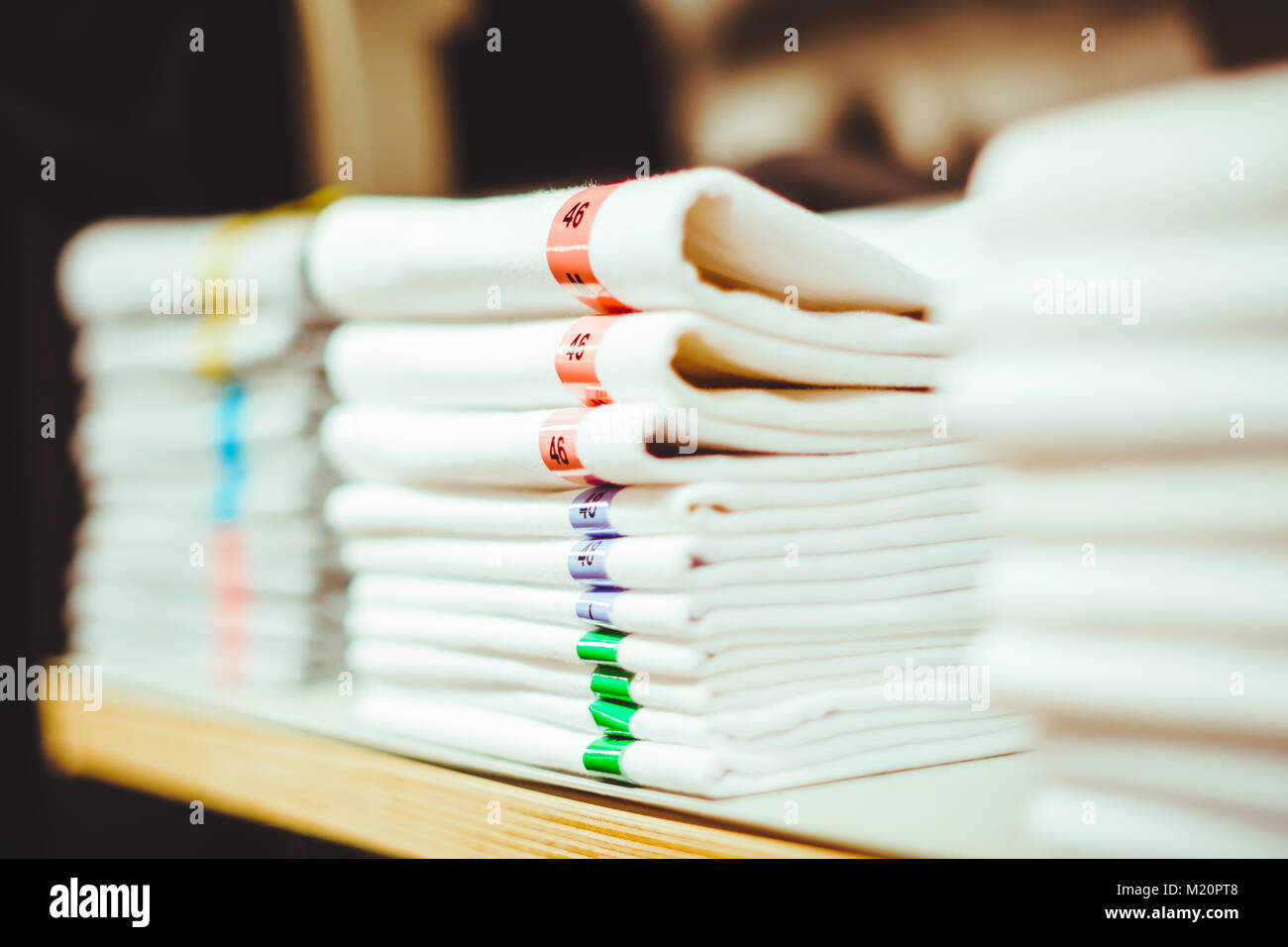 sale shopping background. clothes on shelves in store Stock Photo - Alamy