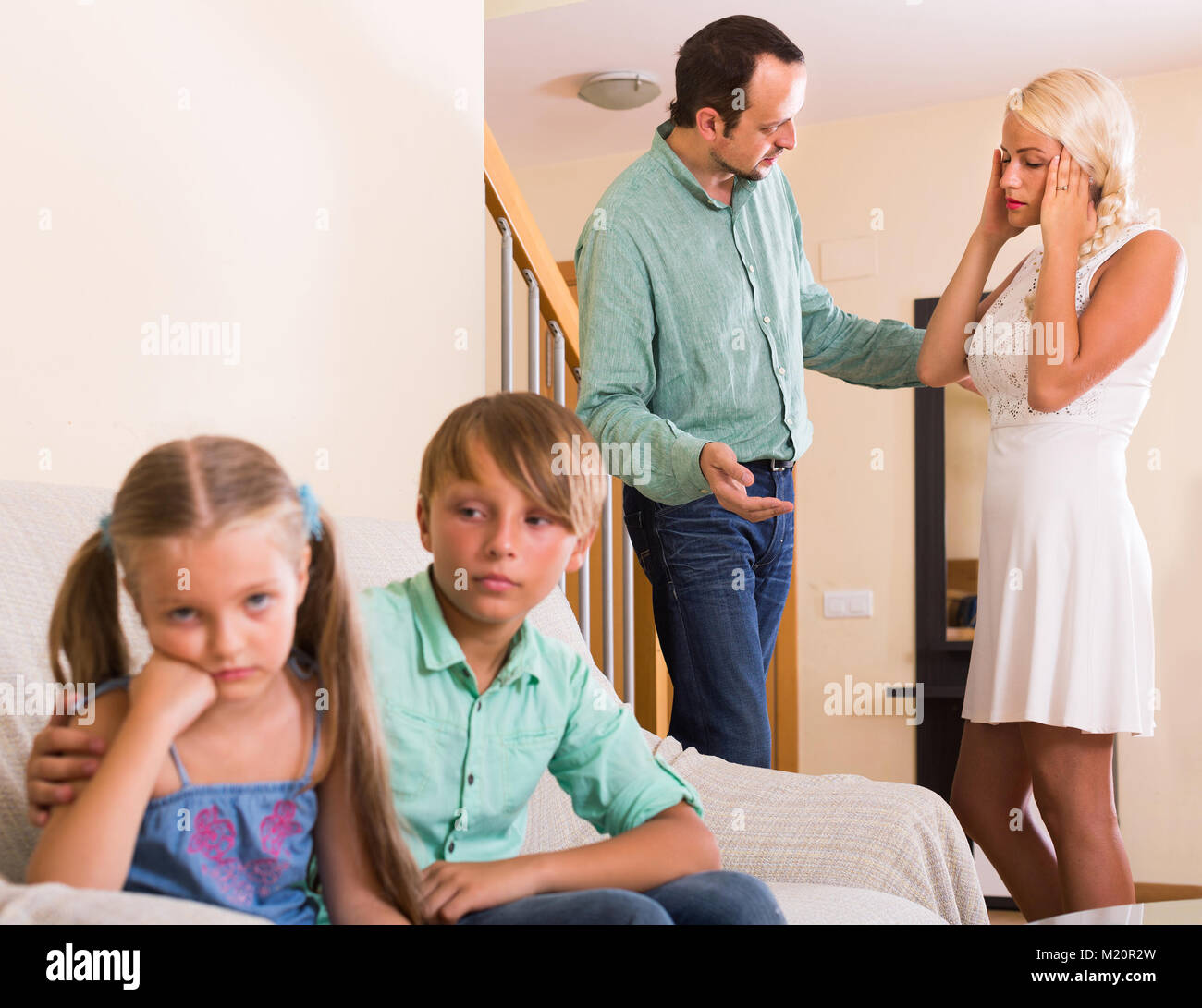 Children in silence while european parents arguing at home. Focus on ...
