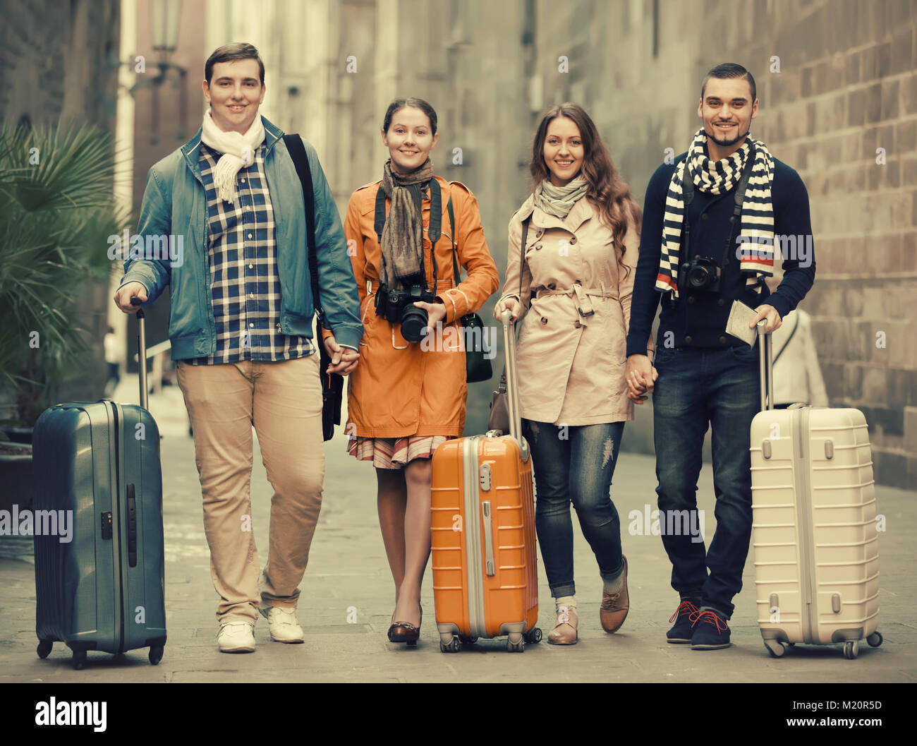 Group of people with trunks walking through city street Stock Photo - Alamy