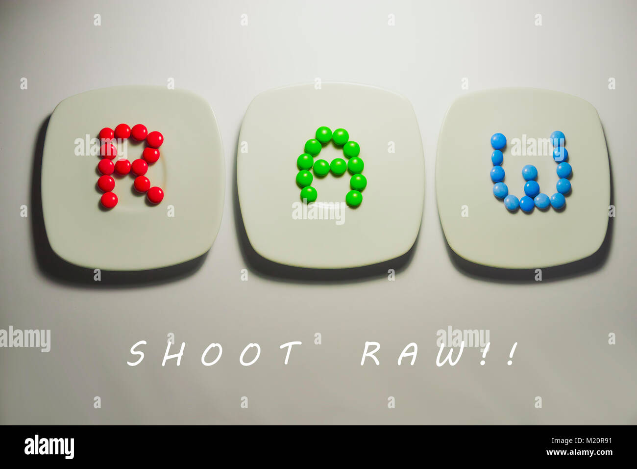 Shoot RAW format with chocolate candies on plates in white background ...