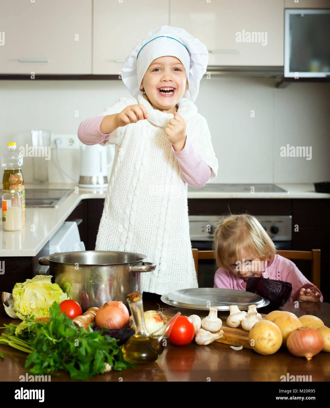 Sisters cooking vegetables in kitchen hi-res stock photography and ...