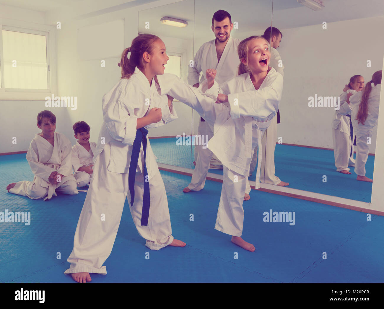 Female teenagers are trying in sparring to use new moves at karate ...