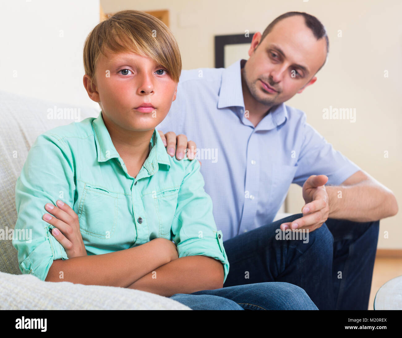 Father trying to reconcile with stubborn teenager after quarrel Stock ...