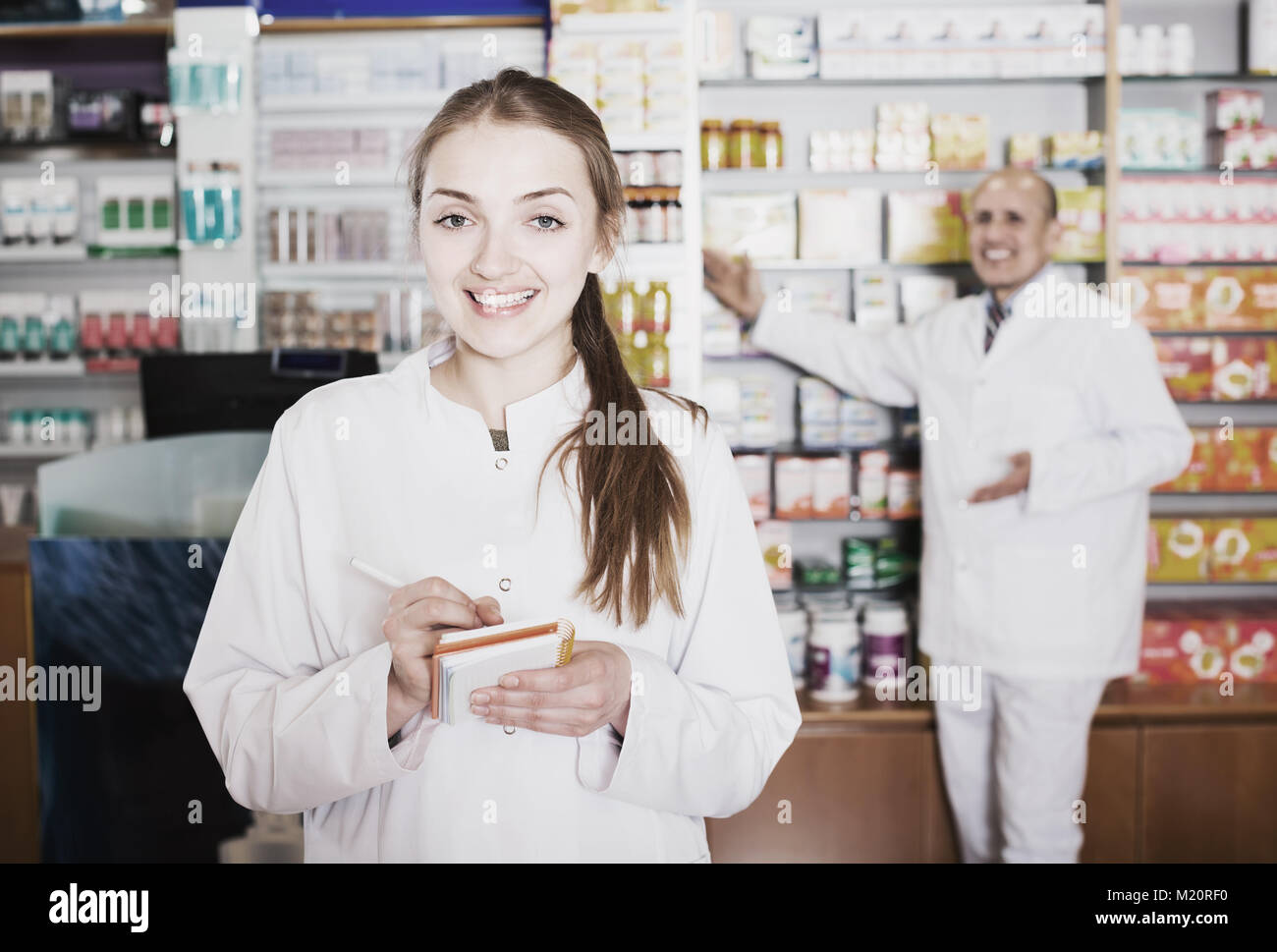 Professional team of pharmaceutist and technician working in pharmacy ...