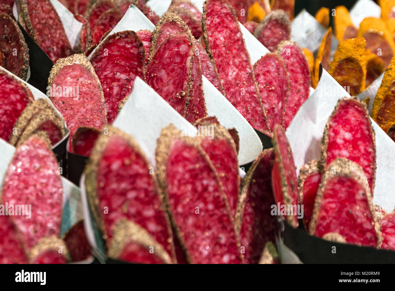 Europe, Spain, Barcelona. Pieces of sliced and pre-packaged salami in ...