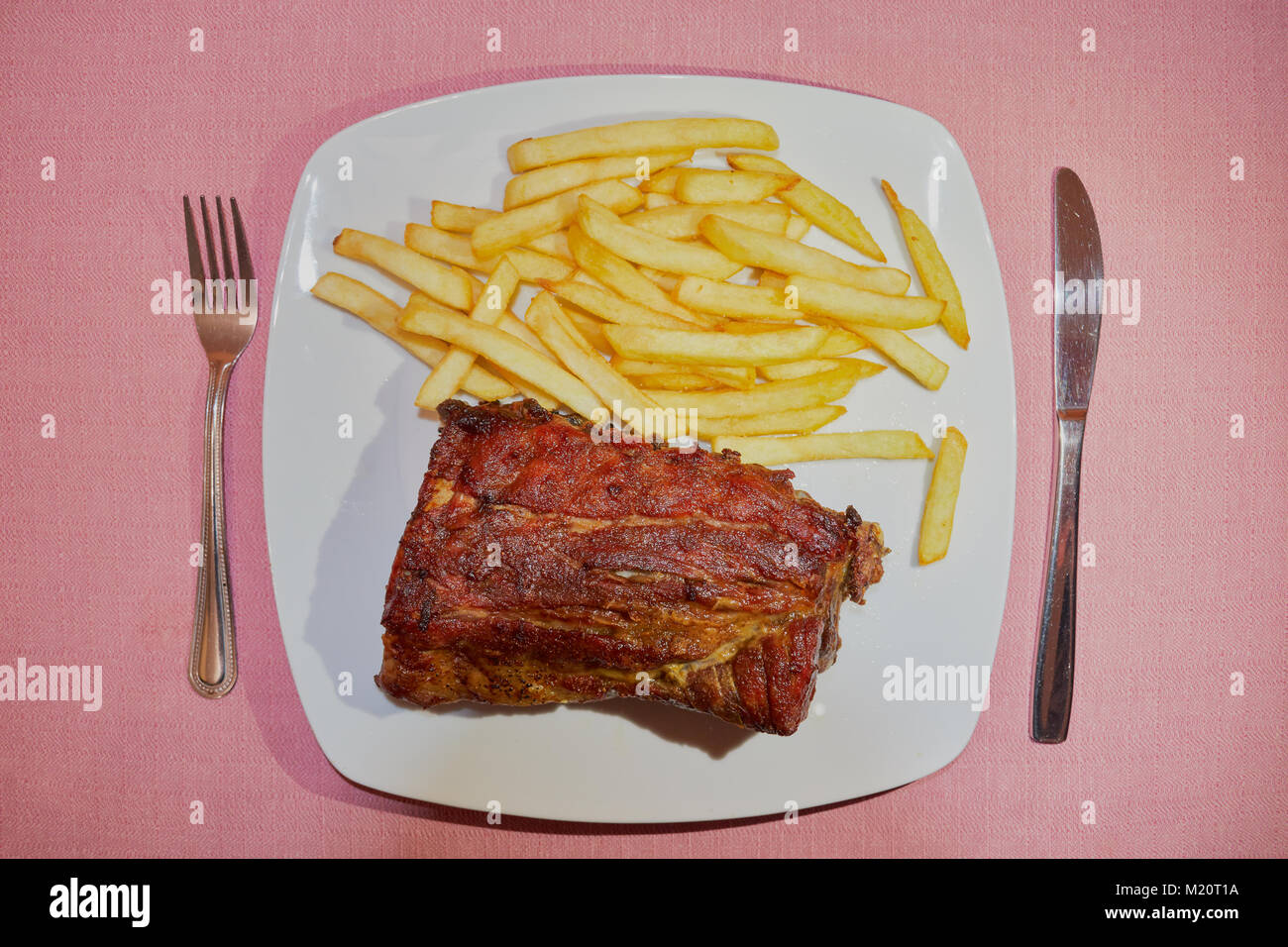 Rack of barbecued pork baby back ribs with french fries and dipping ...
