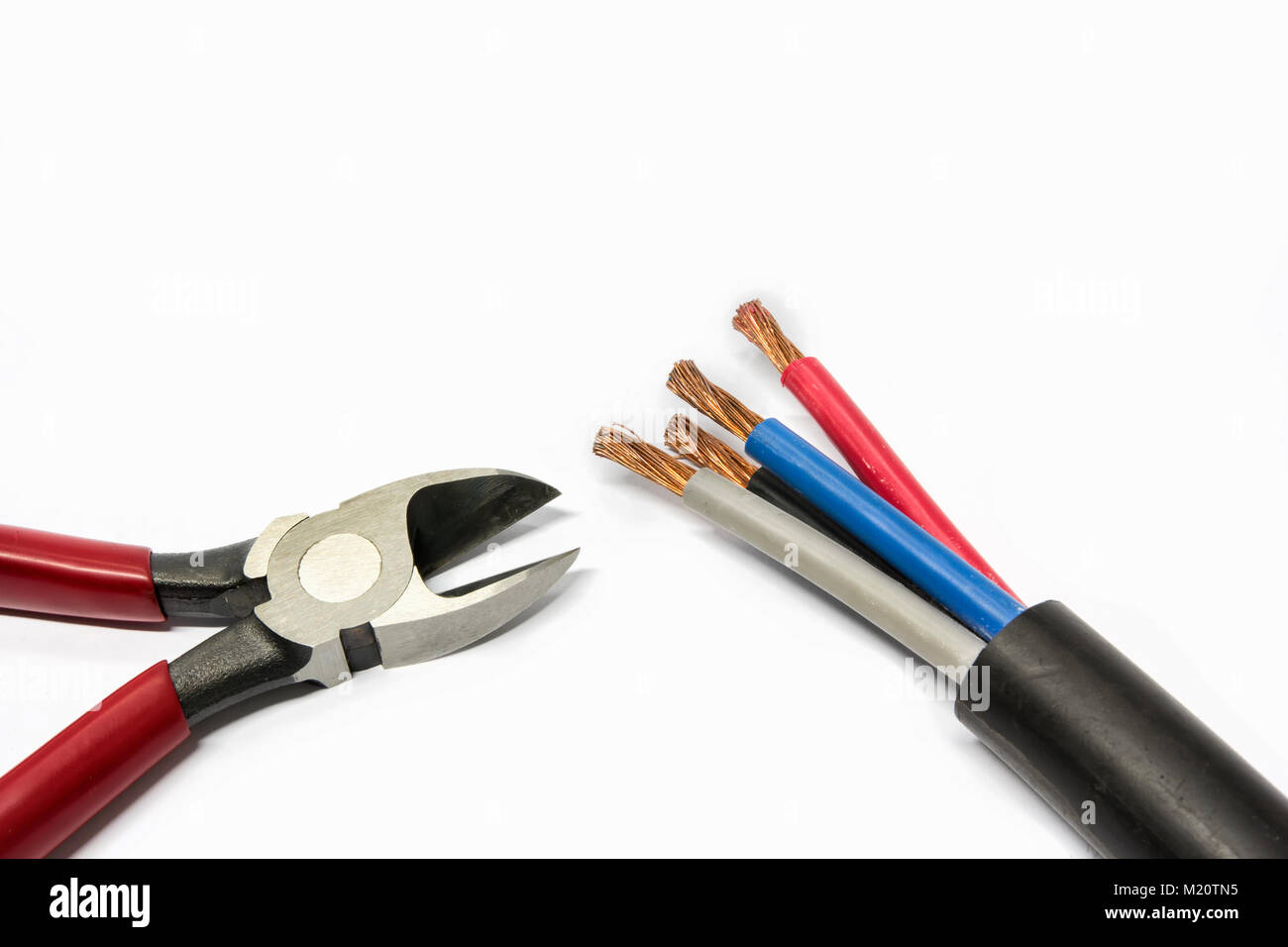 Electric cable cut with pliers on white background Stock Photo - Alamy