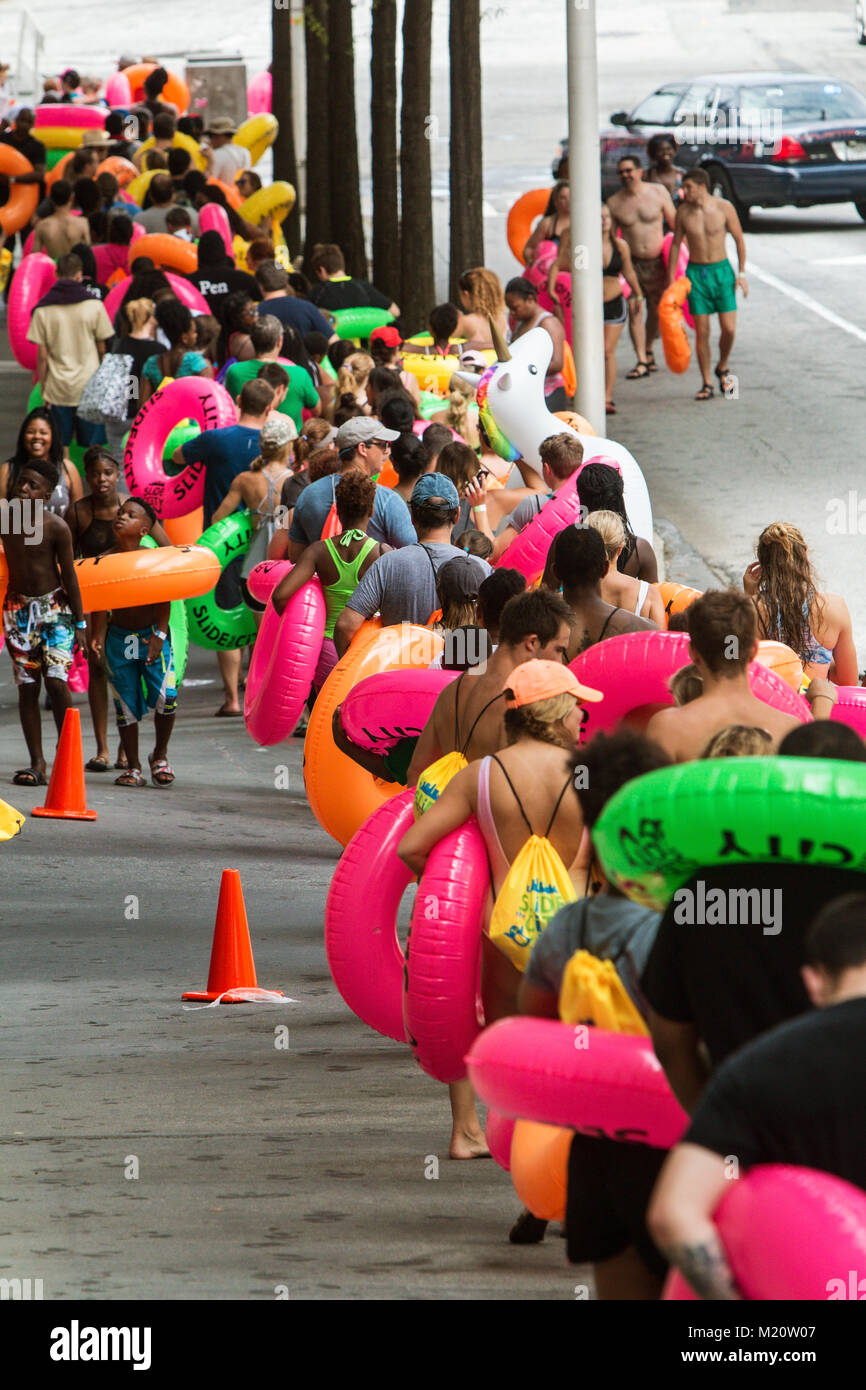Atlanta, GA, USA - July 15, 2017: Dozens of people stand in a long line ...