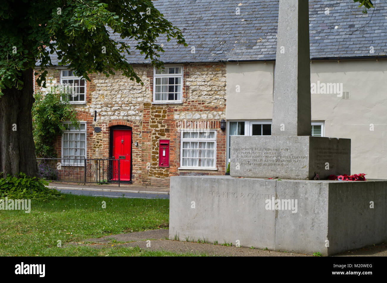The village green in Sedgeford, Norfolk, UK; a stone cottage with a ...