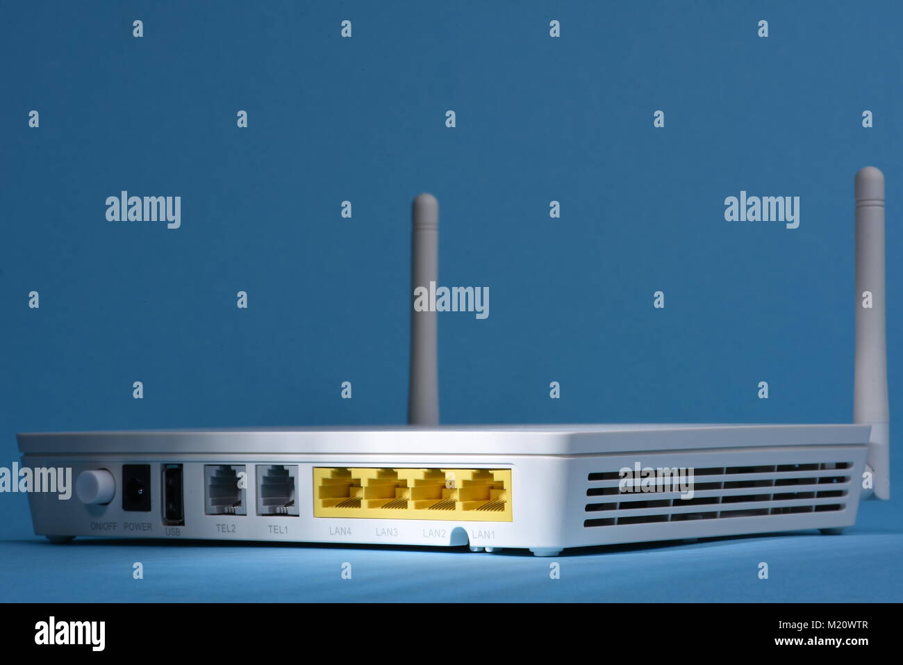 Wireless router network with cable on blue background Stock Photo - Alamy