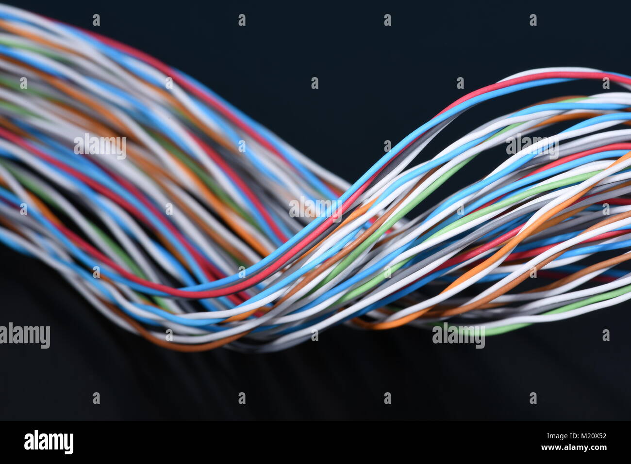 Multicolored electrical cable on dark background Stock Photo - Alamy