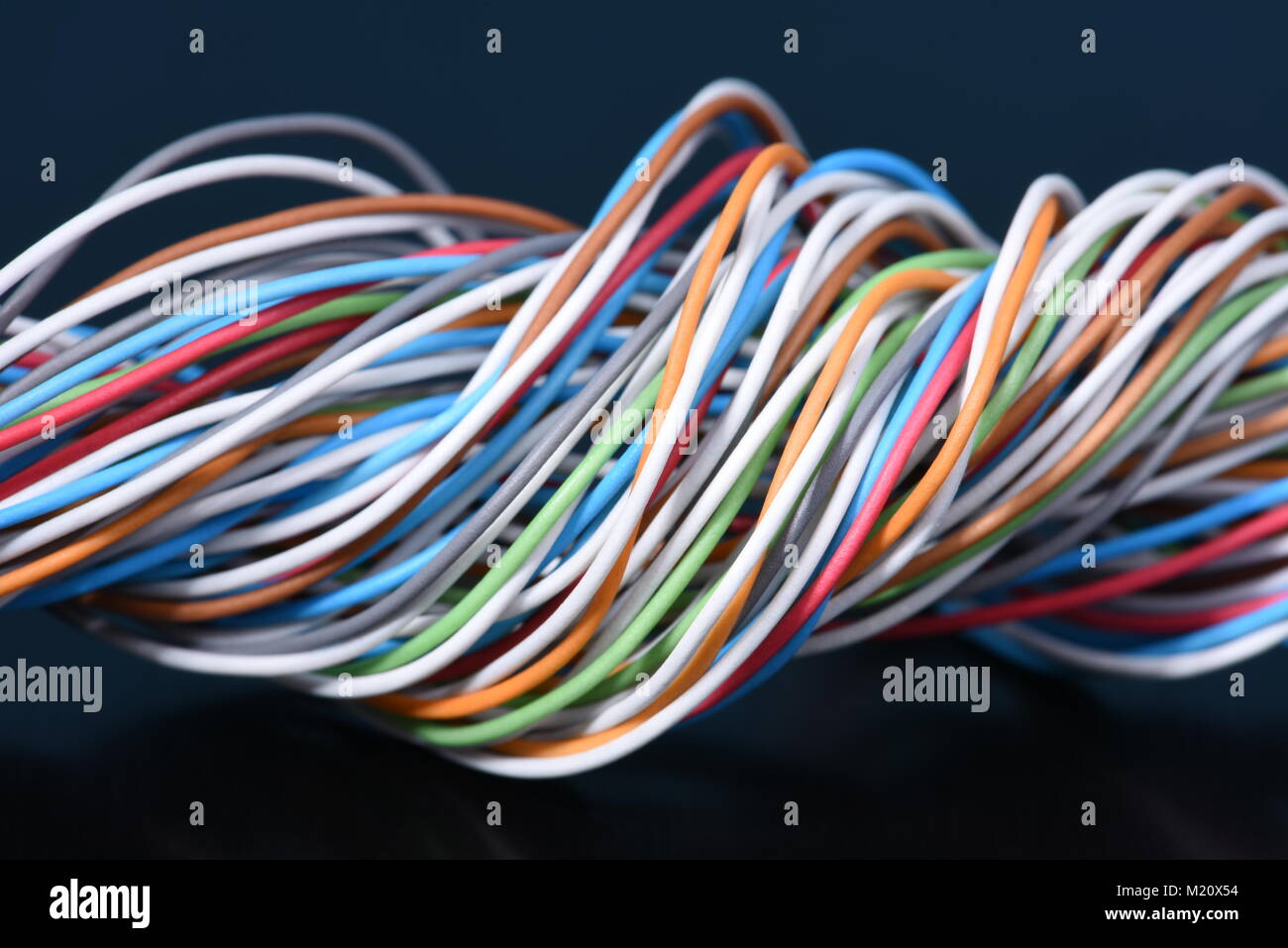 Multicolored electrical cable on dark background Stock Photo - Alamy