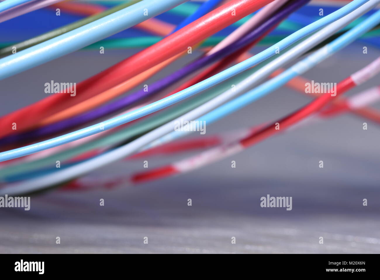 Electrical cables on metal background Stock Photo - Alamy