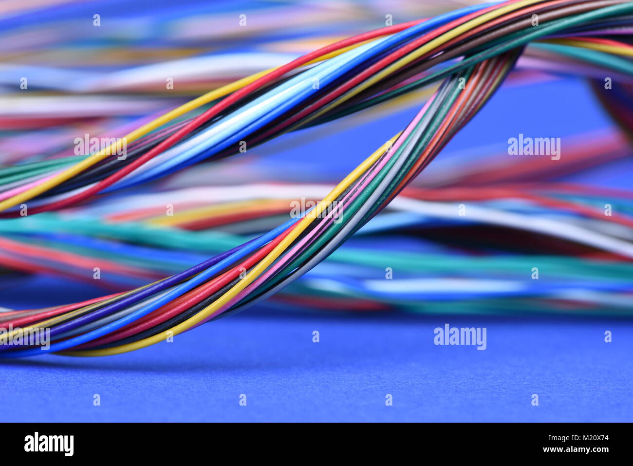 Colorful electrical cables on blue background Stock Photo - Alamy