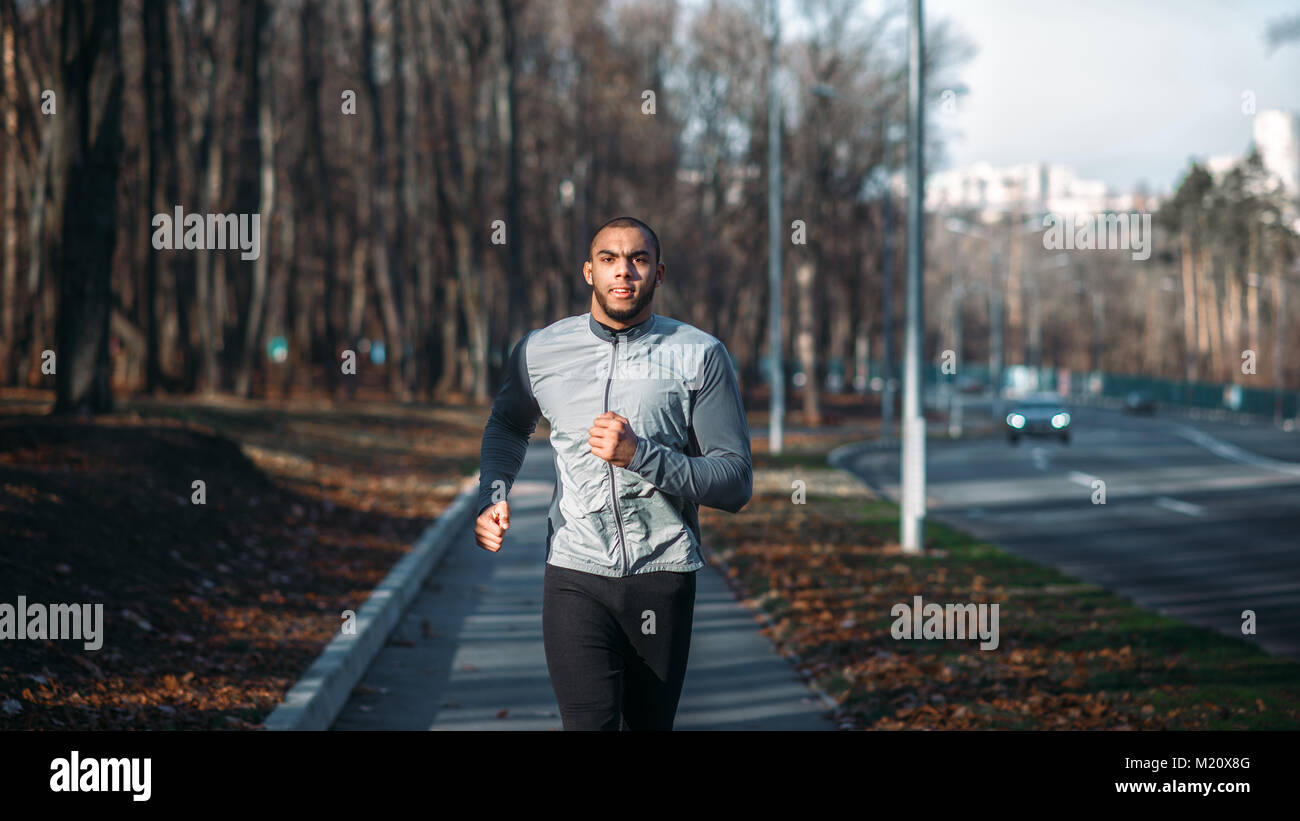 Male runner in sportswear on training outdoor. Jogger on morning ...
