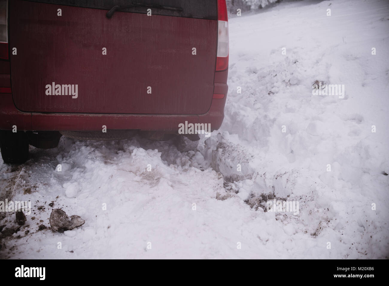 red car trapped in snow, out of the road Stock Photo - Alamy