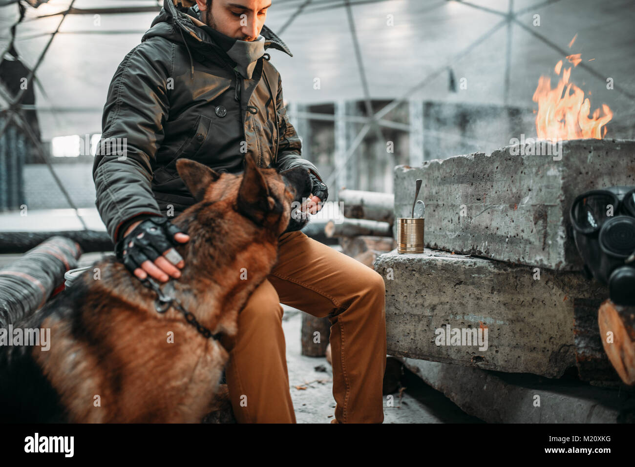 Stalker, post-apocalypse soldier feeding a dog. Post apocalyptic ...