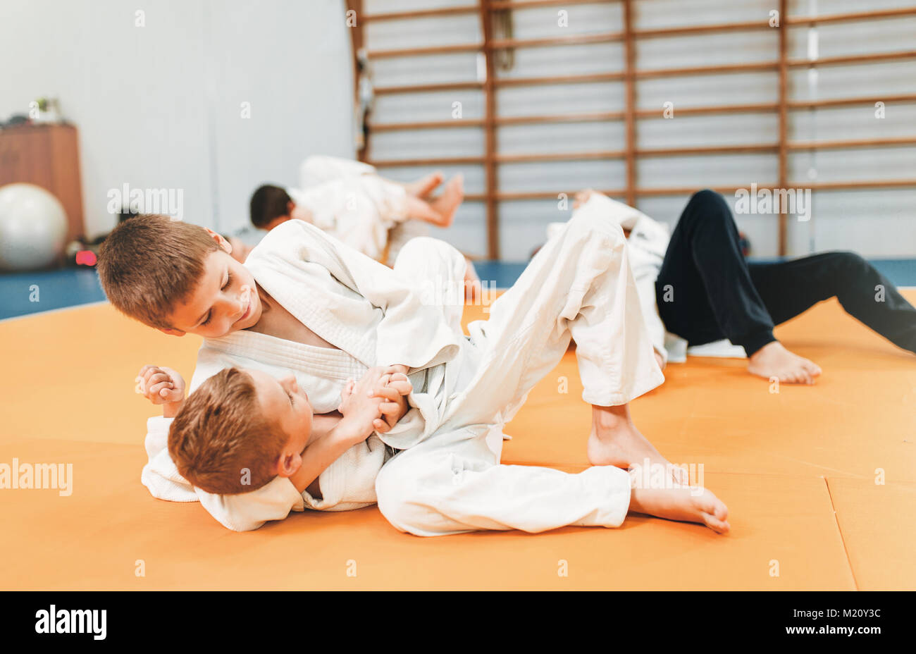 Little boys in uniform practice kid judo. Young fighters on training in ...