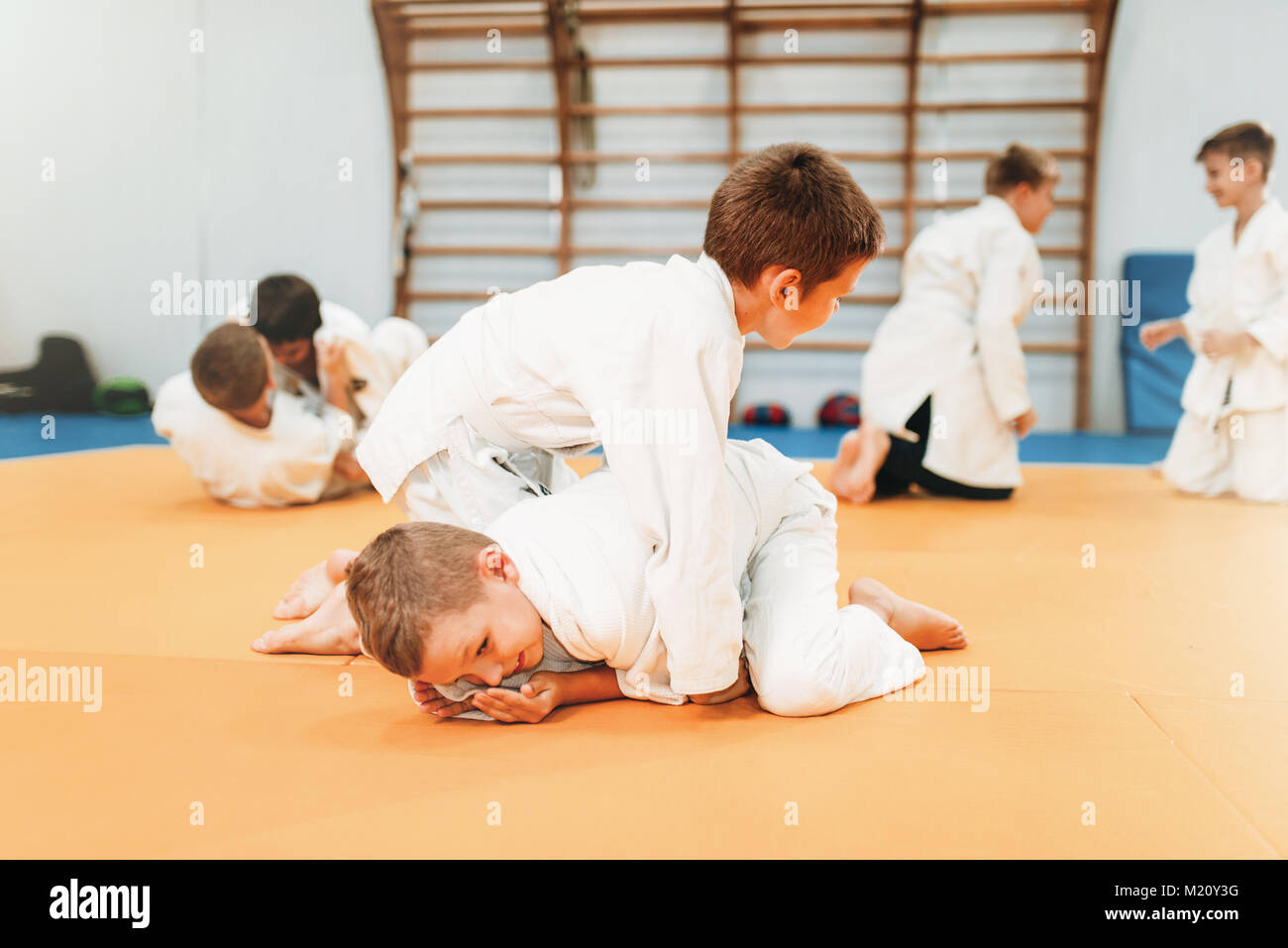 Little boys in uniform practice kid judo. Young fighters on training in ...