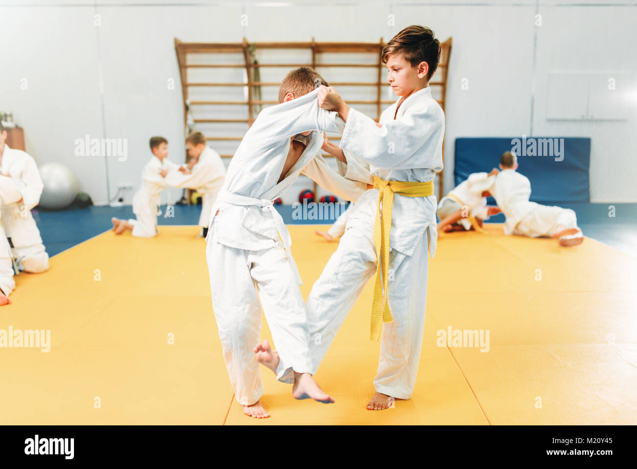 Boys in kimono fights, kid judo training. Young fighters in gym, martial art for defense Stock ...