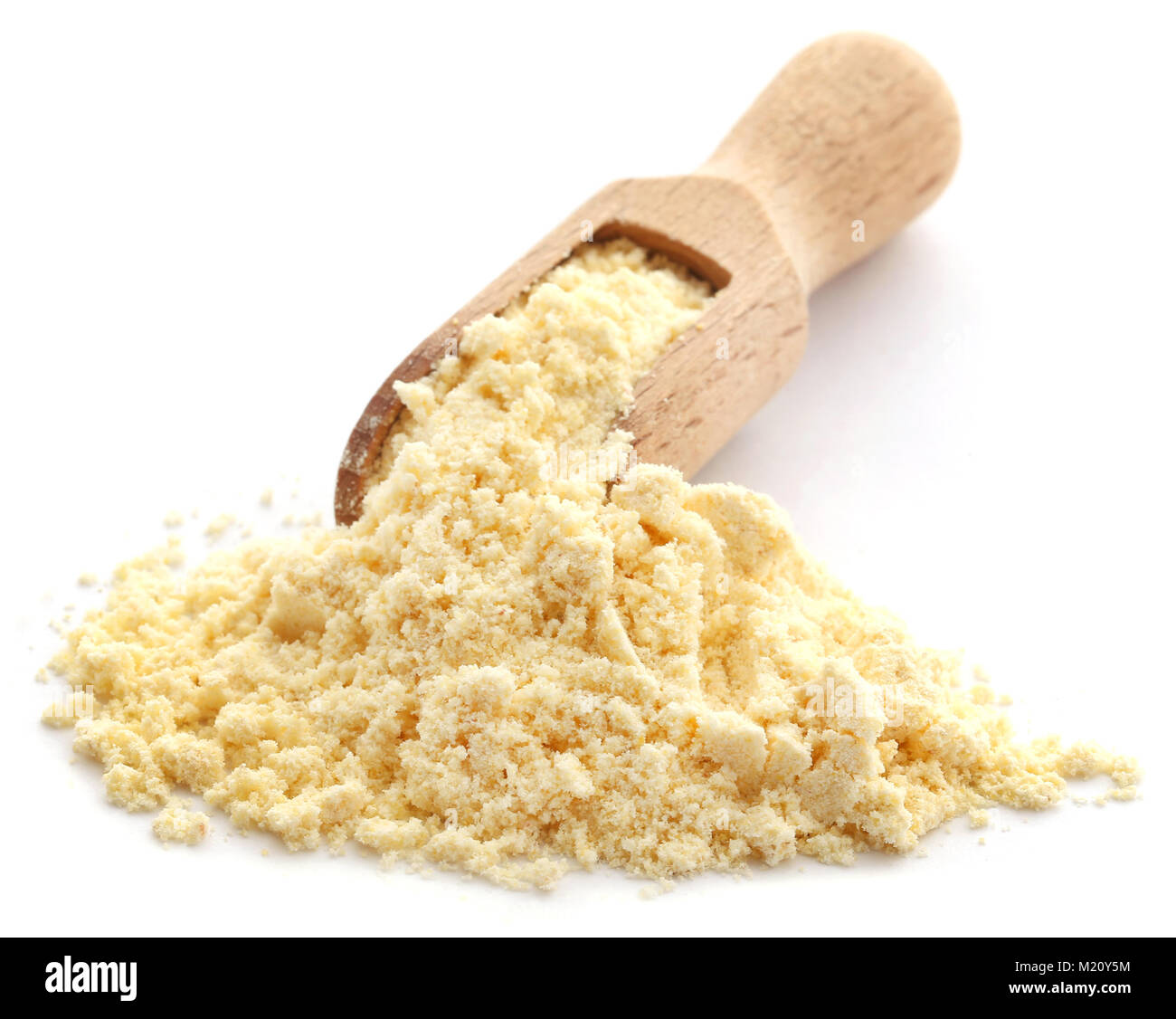 Gram flour in a wooden scoop over white background Stock Photo - Alamy