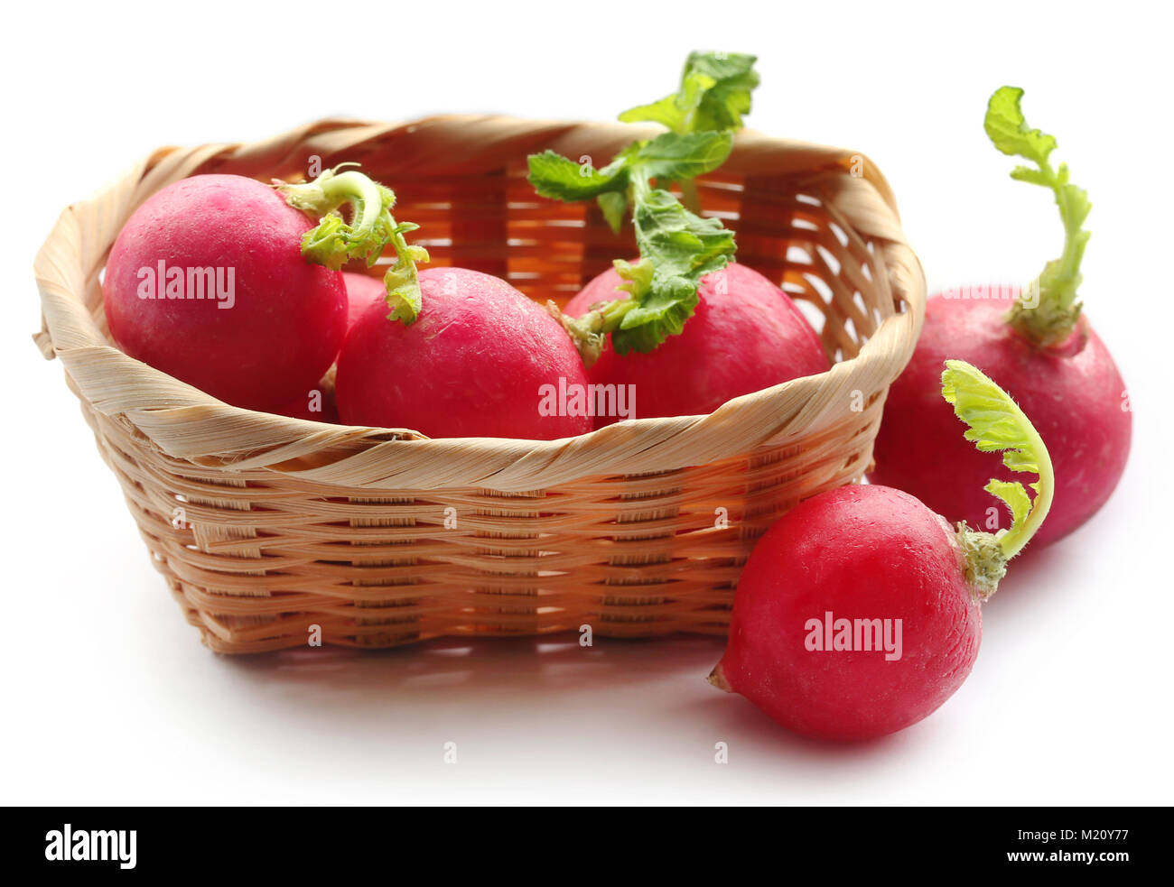 Fresh small radish in a basket over white background Stock Photo - Alamy