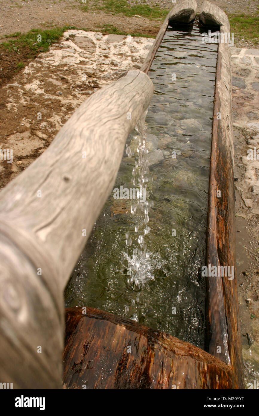 Spring water filling up a wooden trough Stock Photo - Alamy