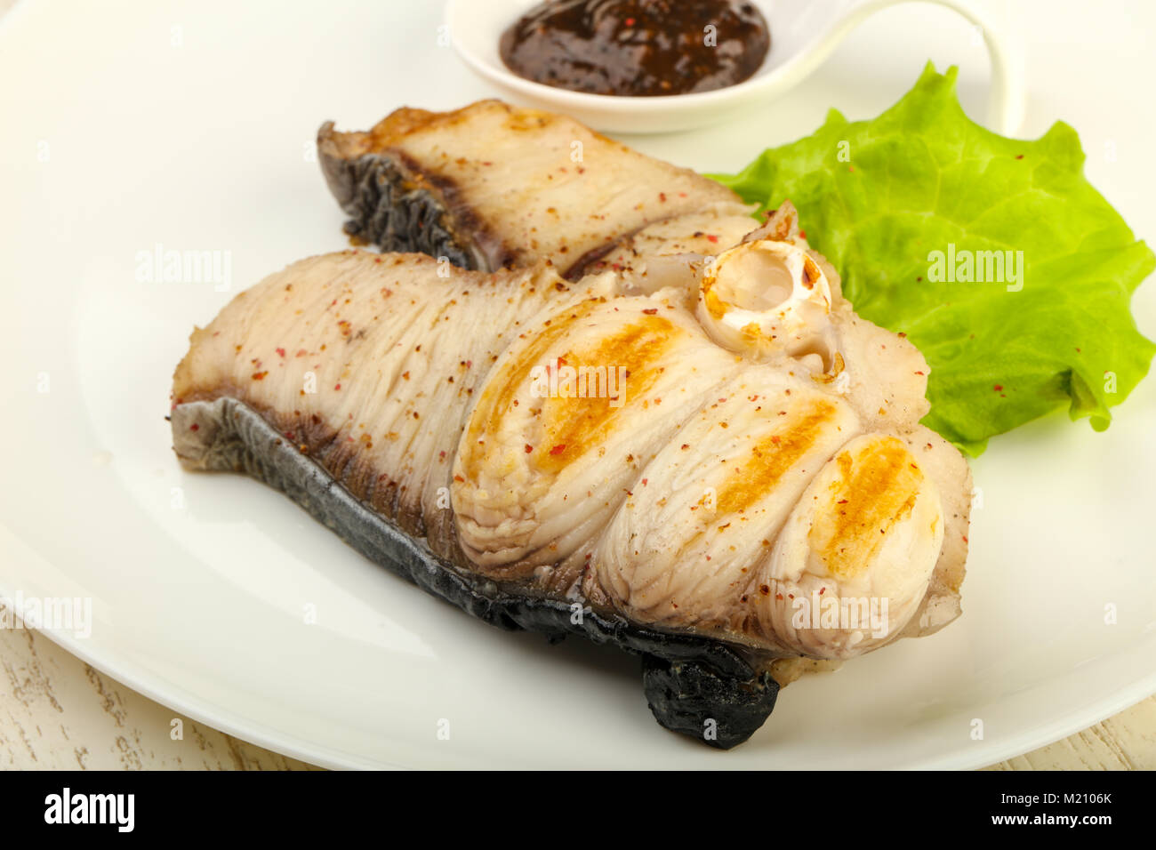 Grilled shark steak with pepper sauce and salad leaves Stock Photo - Alamy