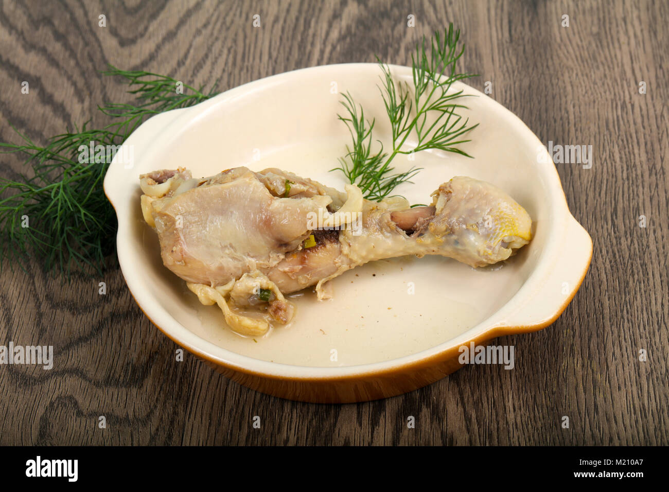 Boiled chicken leg served dill Stock Photo - Alamy