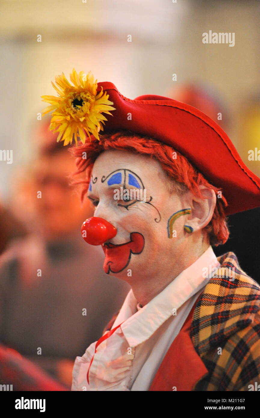 A clown wearing a sunflower during the 67th Annual Grimaldi Clown ...